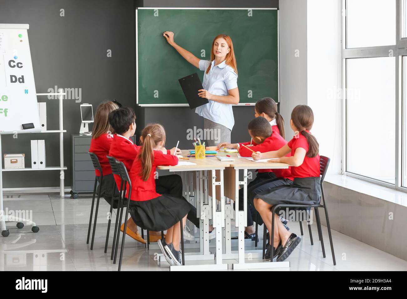 Teacher conducting lesson in classroom Stock Photo - Alamy