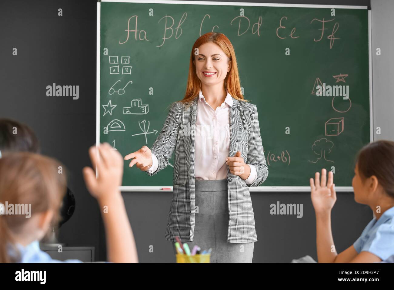 Teacher conducting lesson in classroom Stock Photo - Alamy