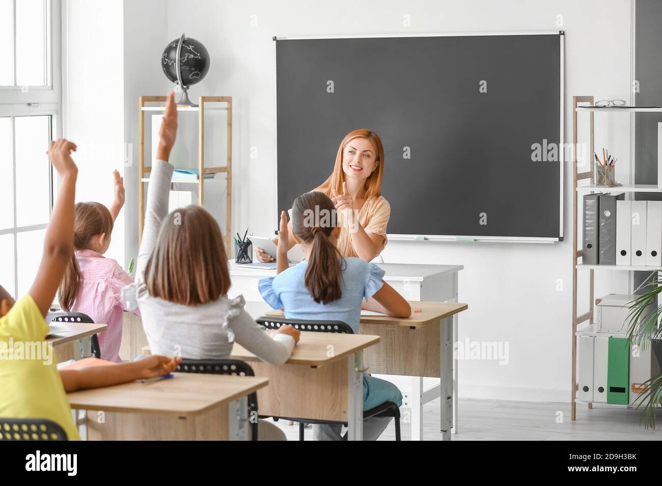 Teacher conducting lesson in classroom Stock Photo - Alamy