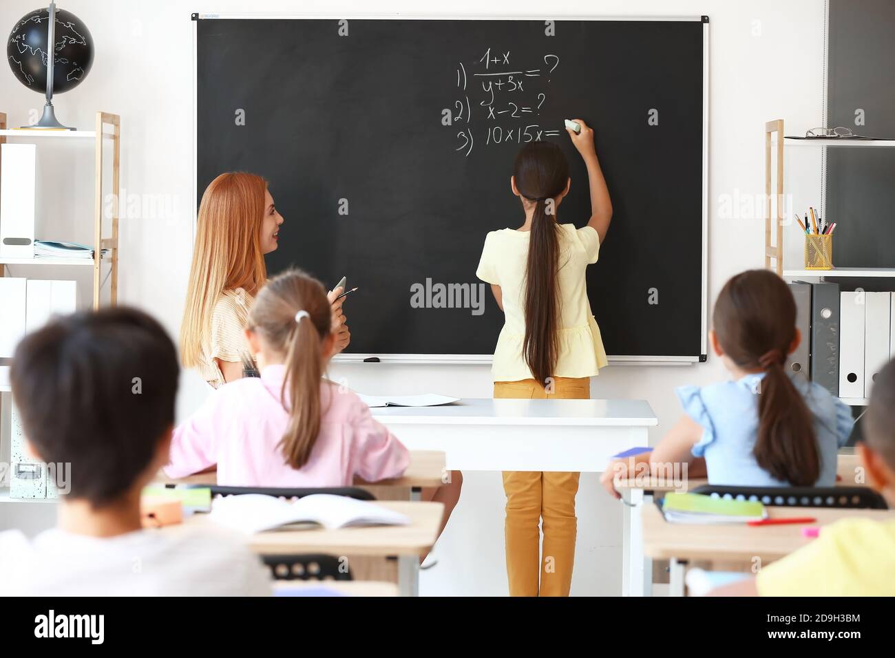 Teacher conducting lesson in classroom Stock Photo - Alamy