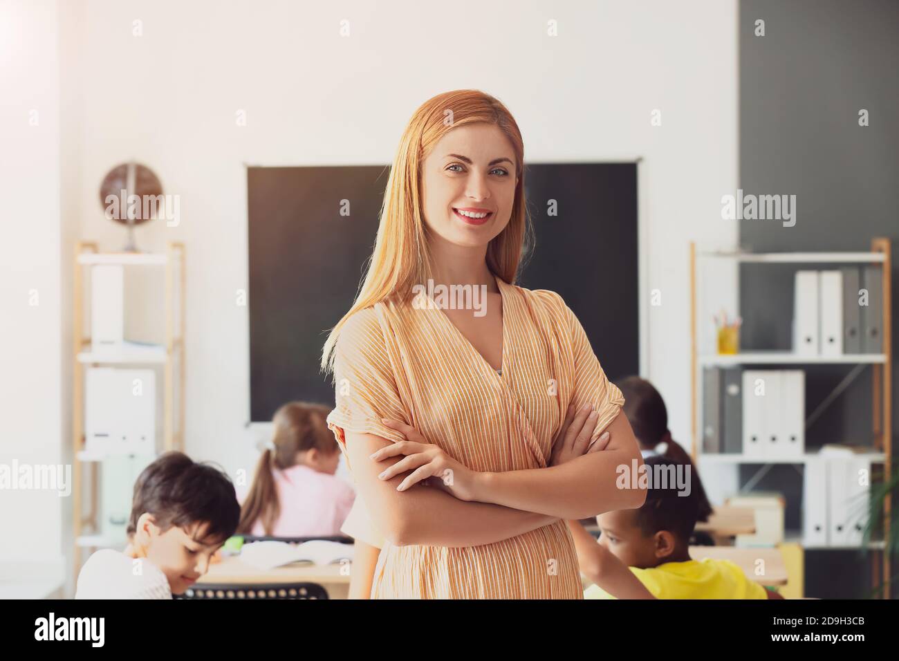 Portrait of beautiful teacher in classroom Stock Photo - Alamy