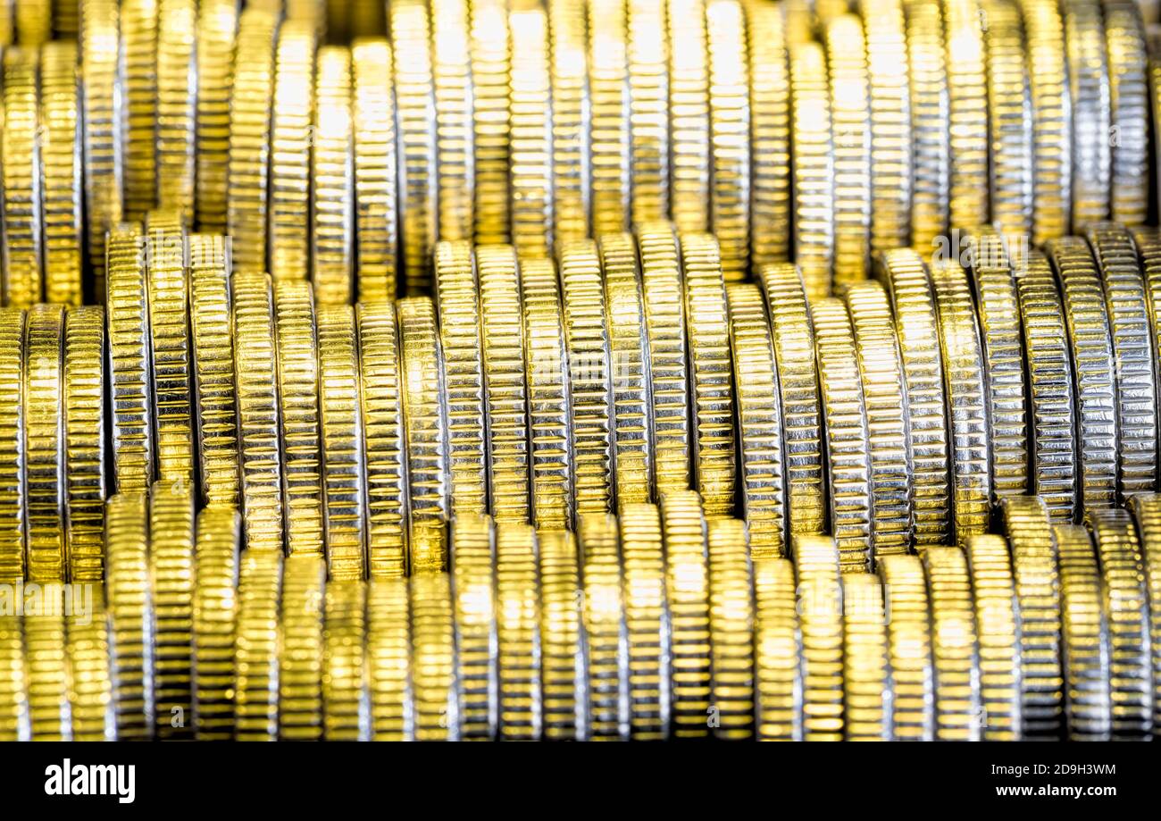 many round metal coins of silver color illuminated with Golden color ...