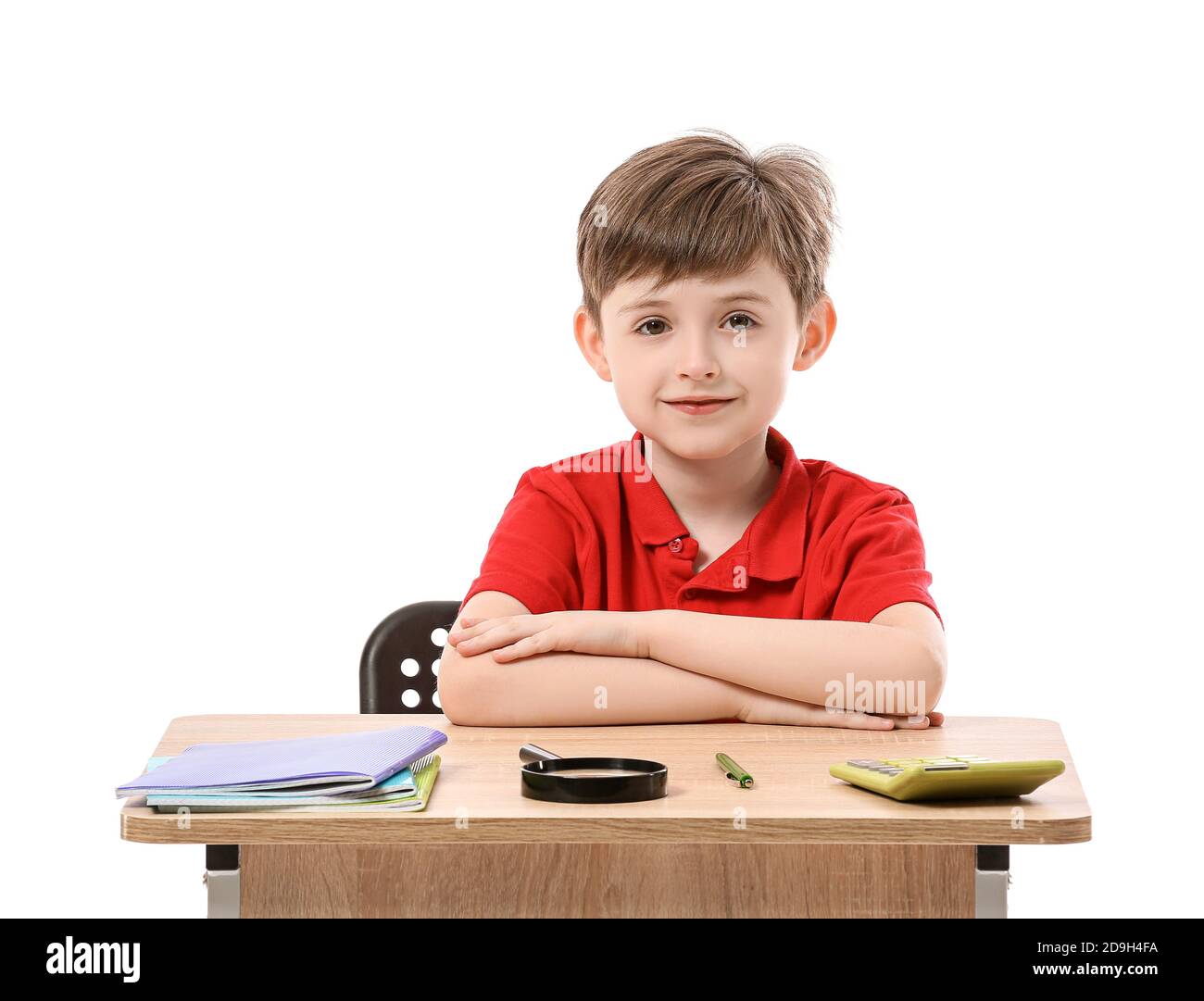 Little pupil sitting at school desk against white background Stock ...