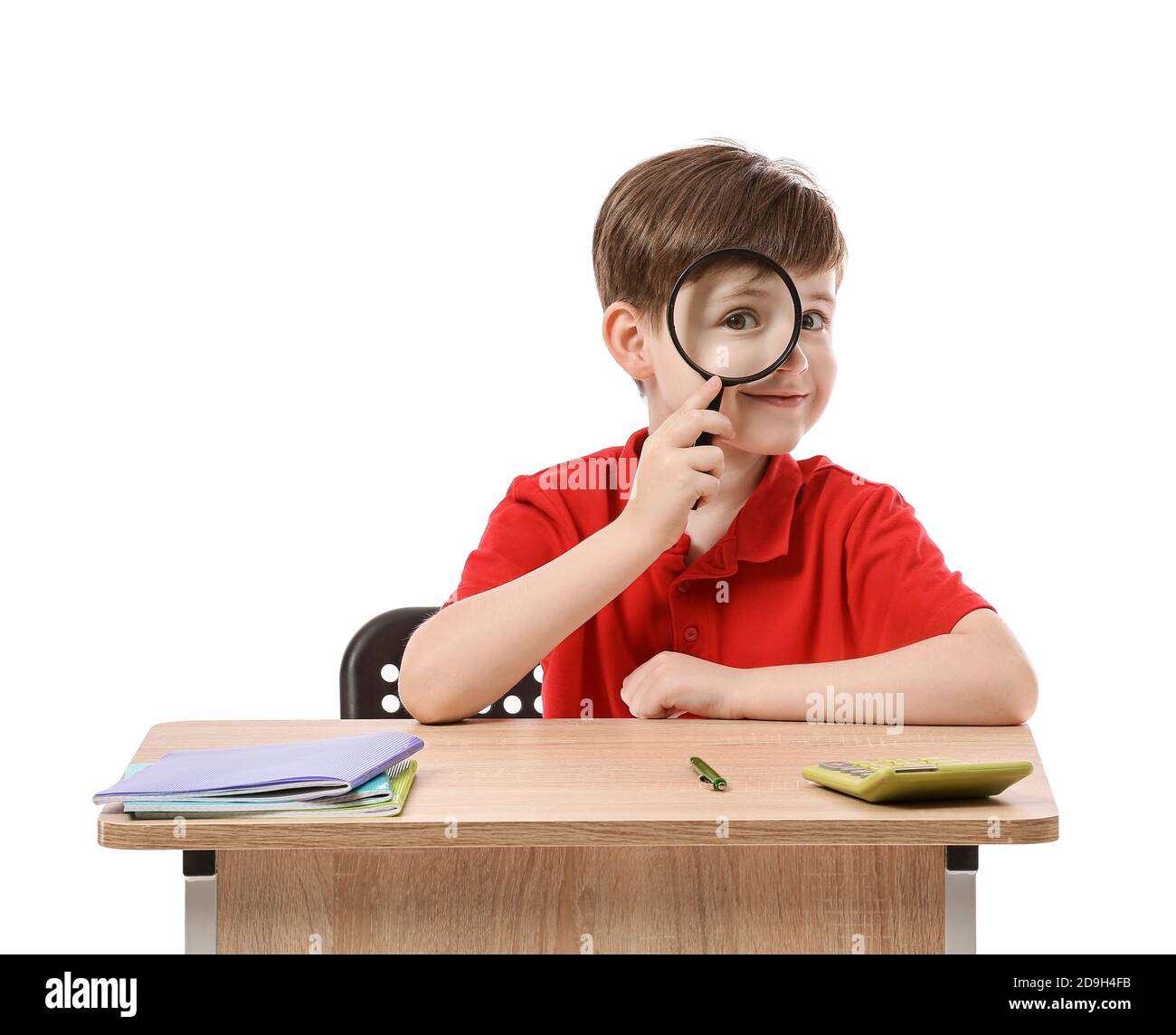 Little pupil sitting at school desk against white background Stock ...