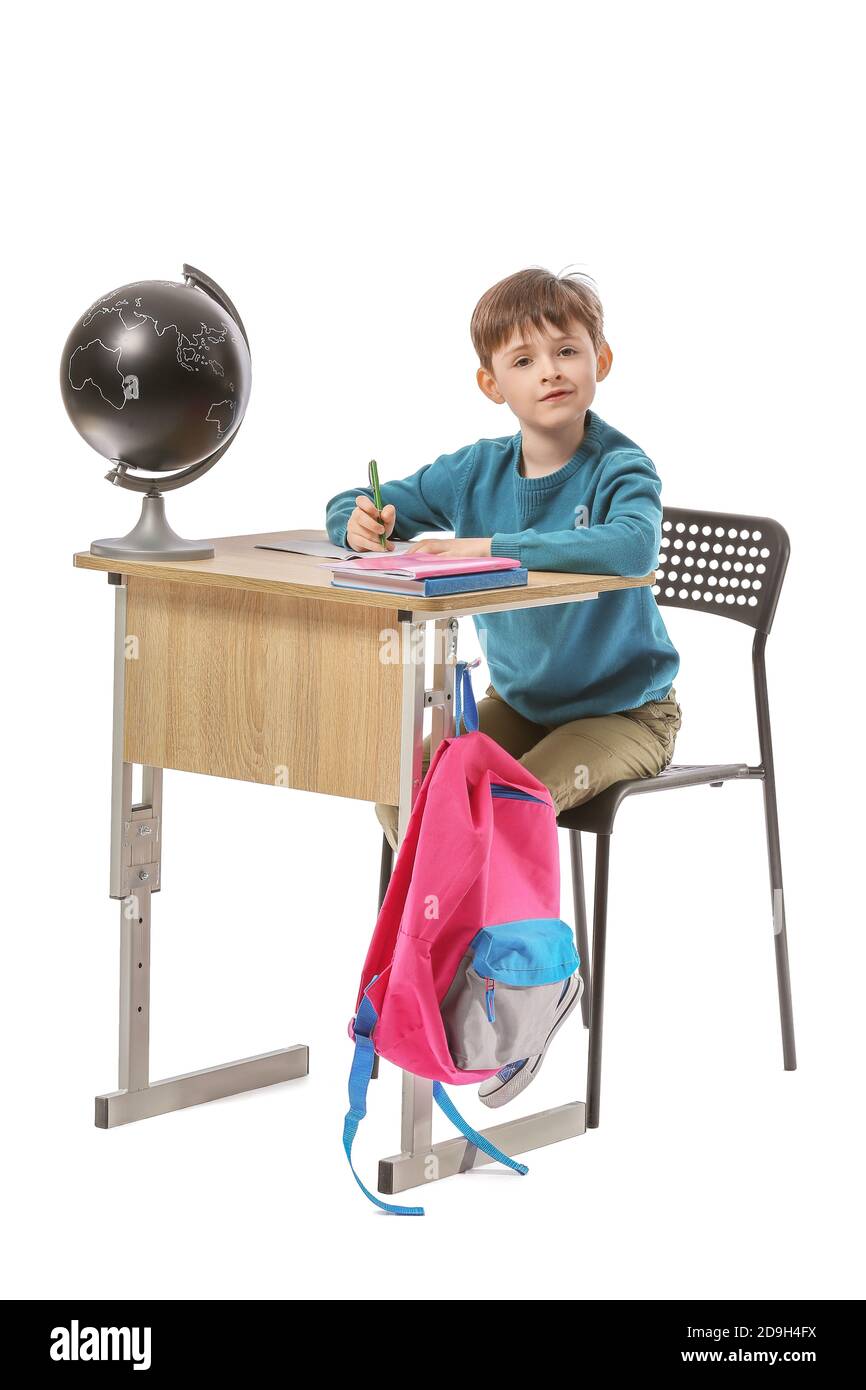 Little pupil sitting at school desk against white background Stock ...