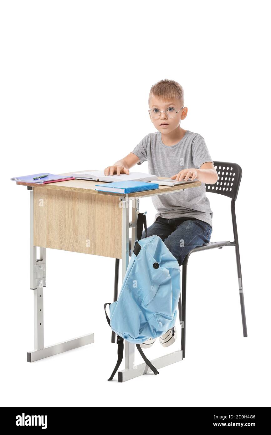 Little pupil sitting at school desk against white background Stock ...