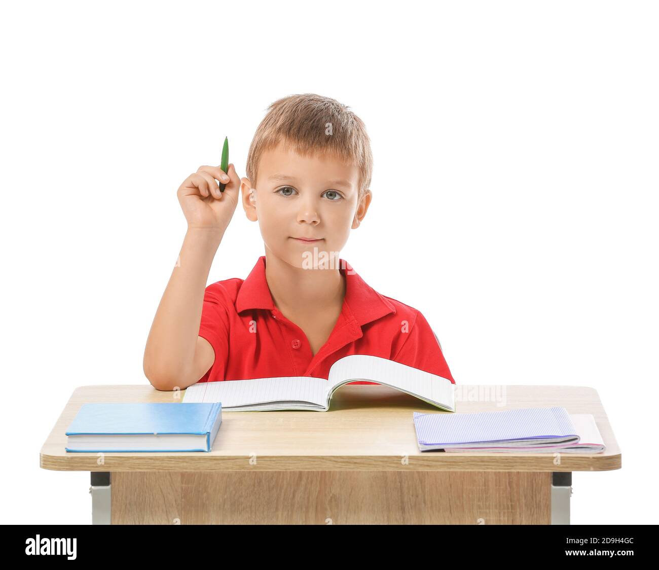 Little pupil sitting at school desk against white background Stock ...