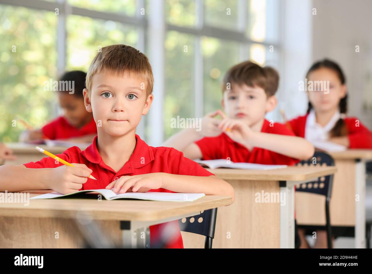 Cute pupils during lesson in classroom Stock Photo - Alamy