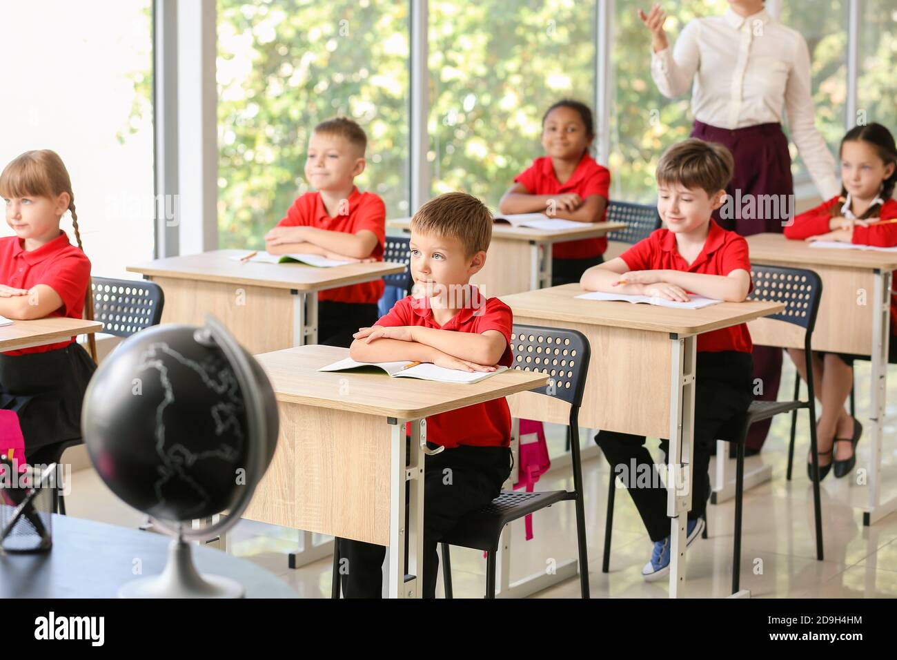 Teacher conducting lesson in classroom Stock Photo - Alamy