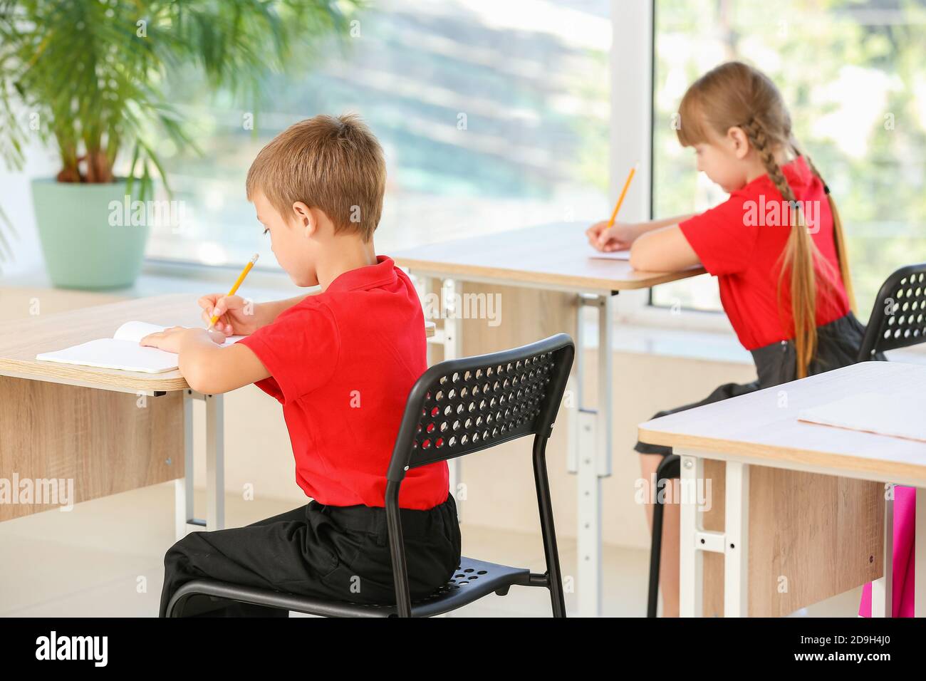 Cute pupils during lesson in classroom Stock Photo - Alamy