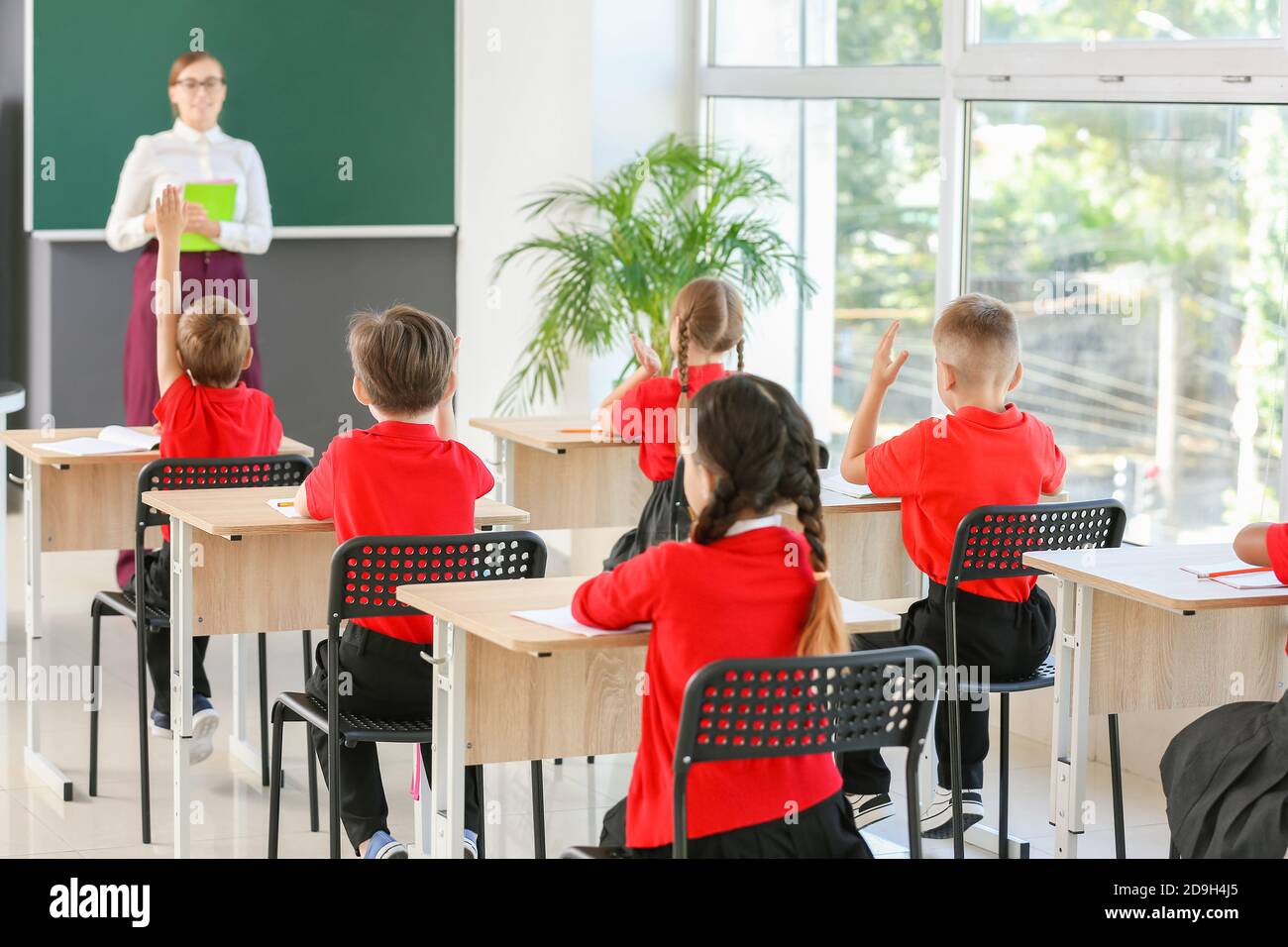 Teacher conducting lesson in classroom Stock Photo - Alamy