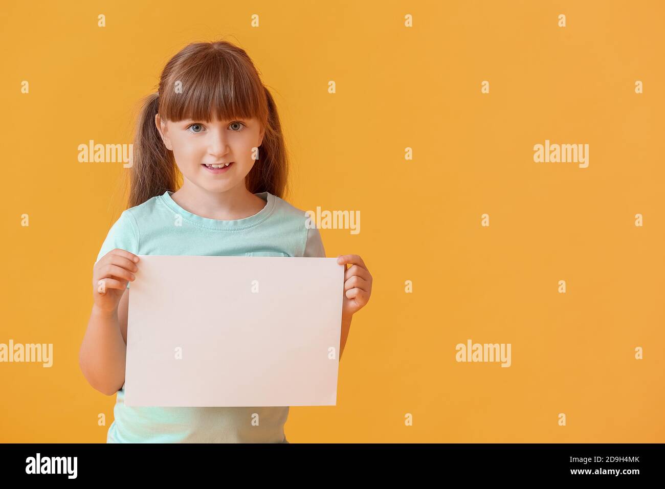 Little girl with blank paper sheet on color background Stock Photo - Alamy