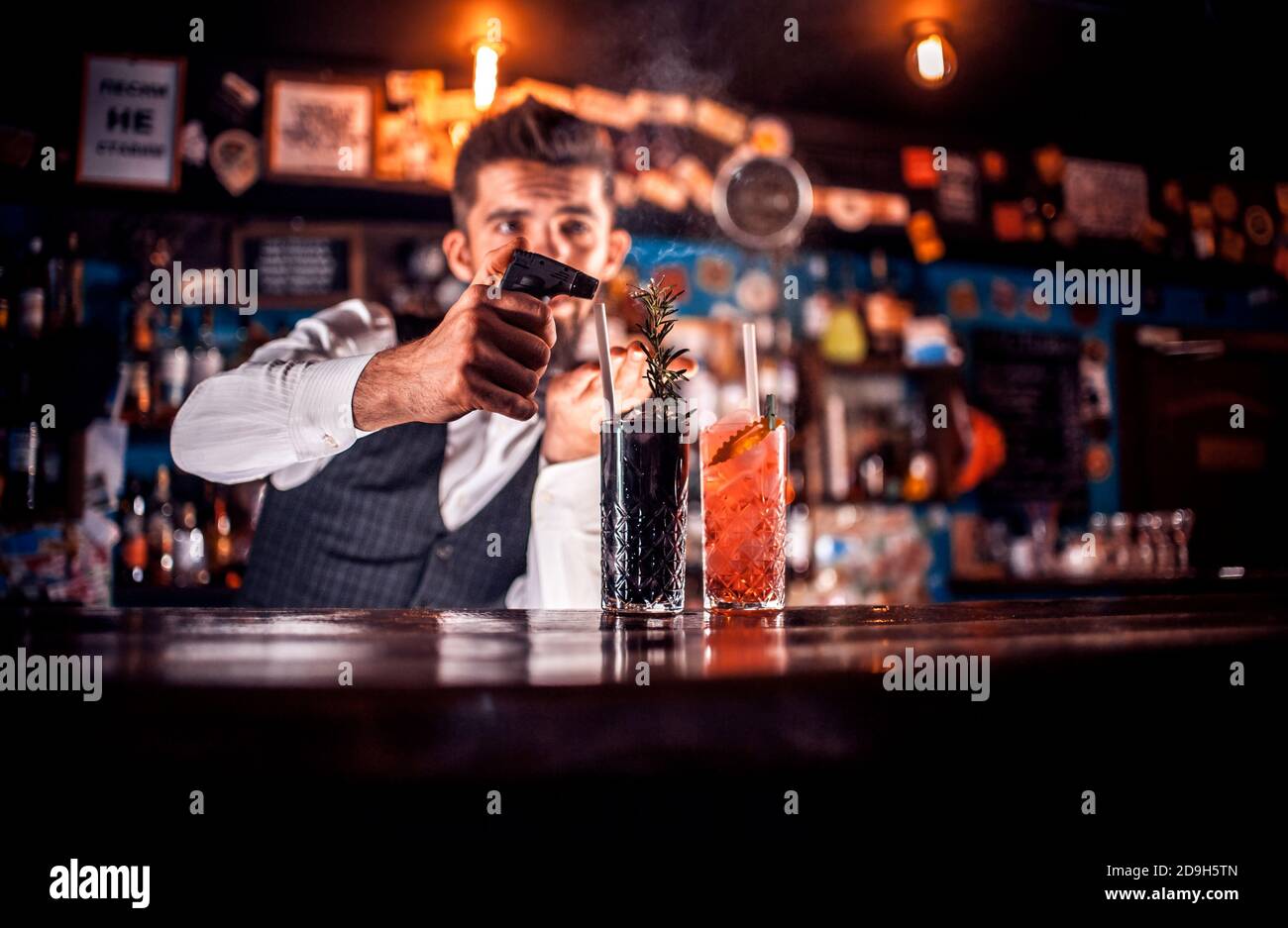 Charming bartender creates a cocktail at the night club Stock Photo - Alamy
