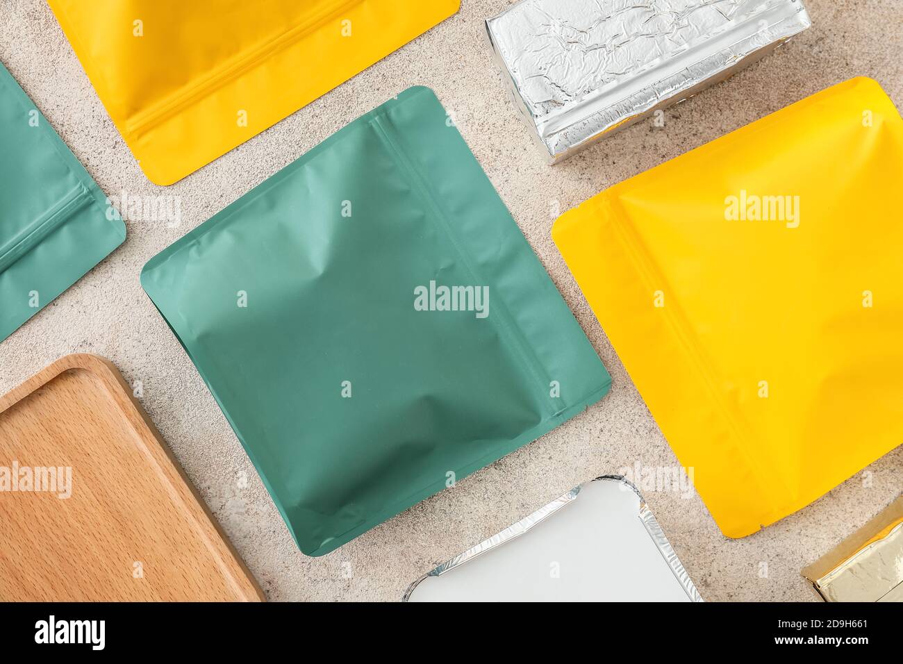 Packages for food on grey background Stock Photo - Alamy