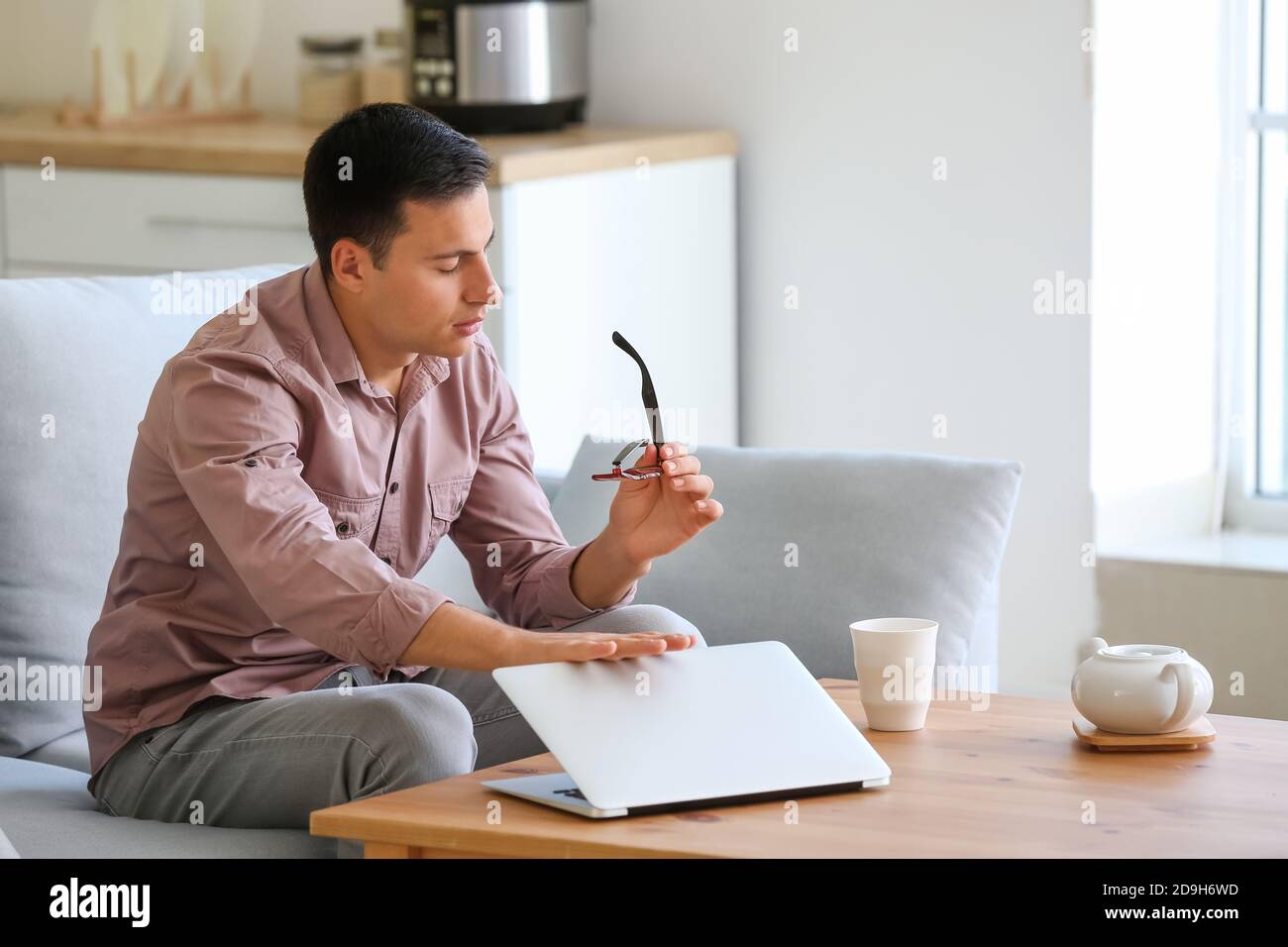 Stressed young man at home Stock Photo - Alamy