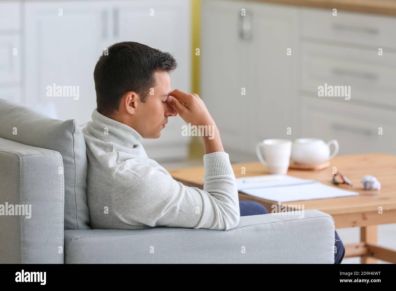 Stressed young man at home Stock Photo - Alamy