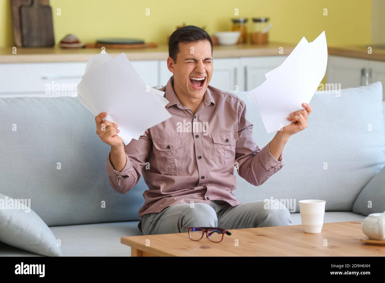 Stressed young man at home Stock Photo - Alamy
