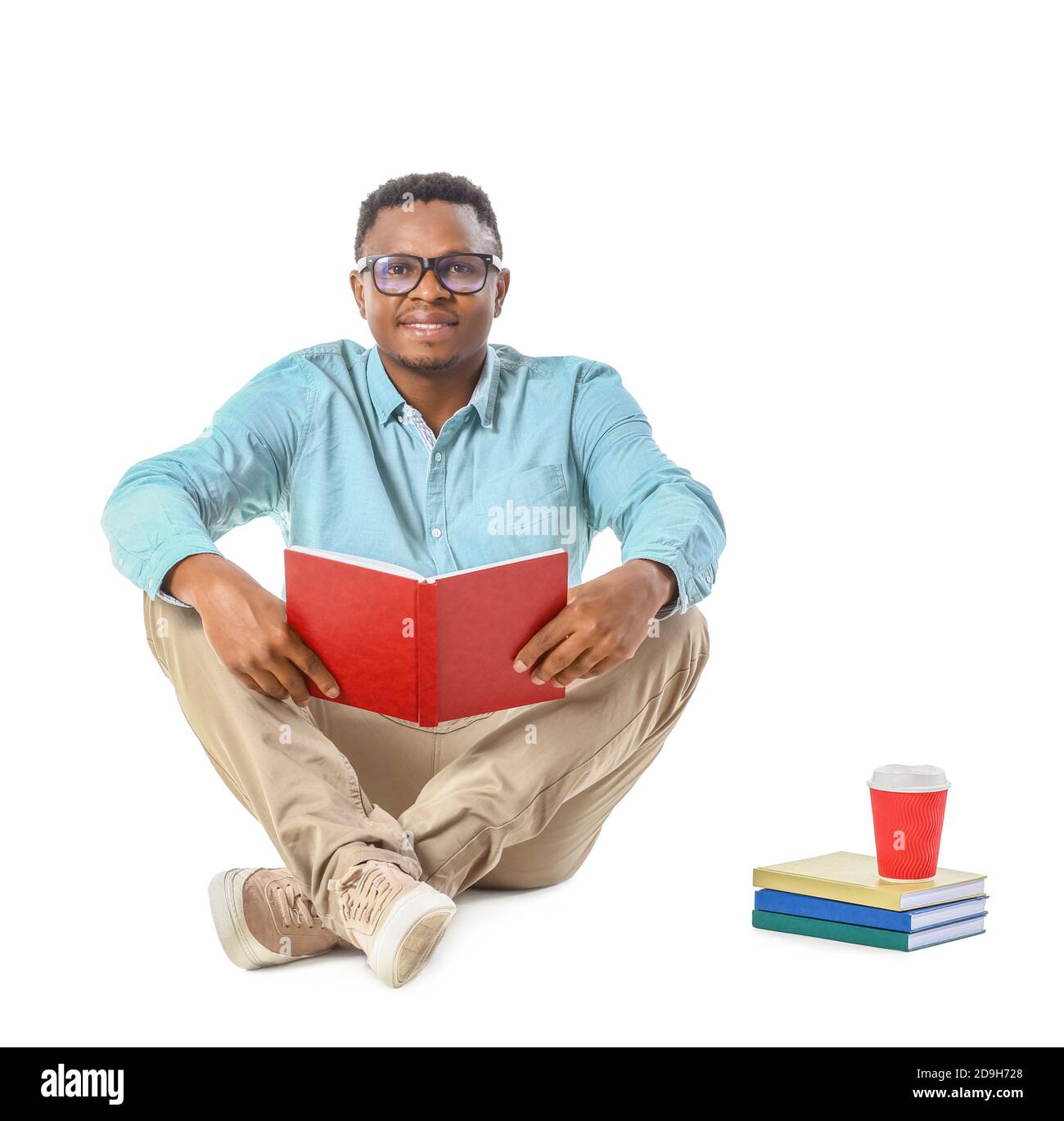African-American man reading book on white background Stock Photo - Alamy