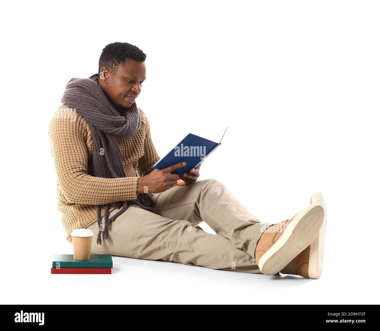 African-American man reading book on white background Stock Photo - Alamy