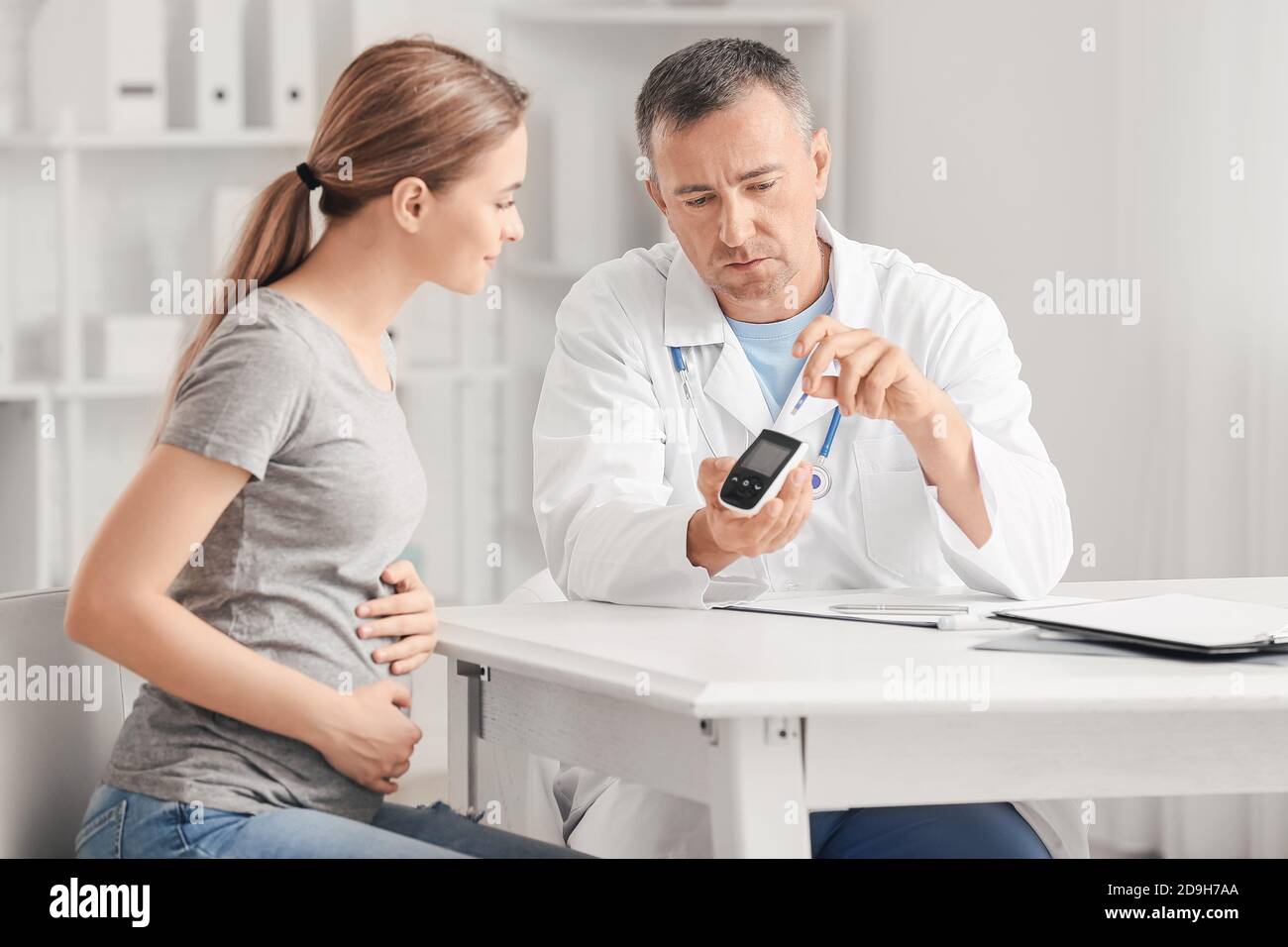 Pregnant diabetic woman visiting doctor in clinic Stock Photo - Alamy