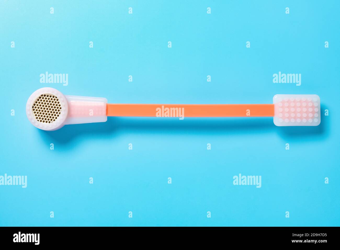 top view traditional Chinese dredge meridian clapper on blue background ...