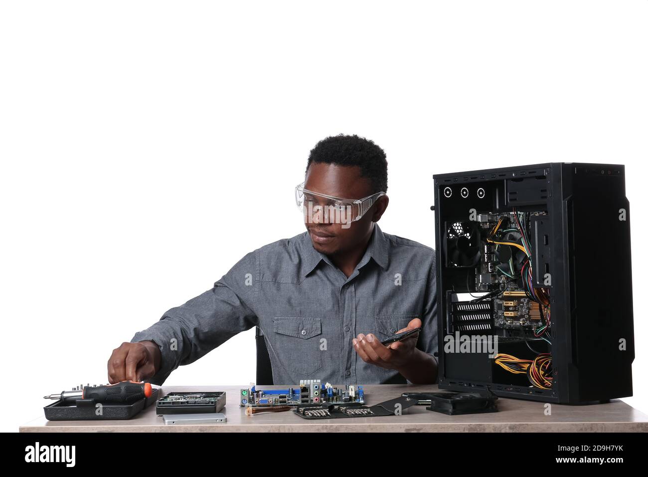 African-American technician repairing computer on white background ...