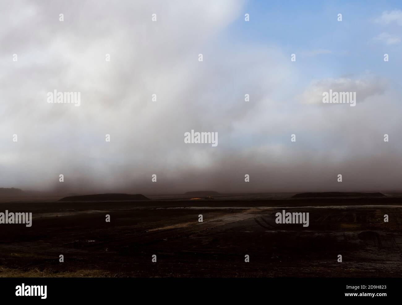dust from peat excavations flying against the sky Stock Photo - Alamy