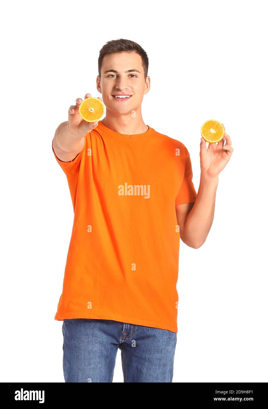 Handsome man with ripe orange on white background Stock Photo - Alamy