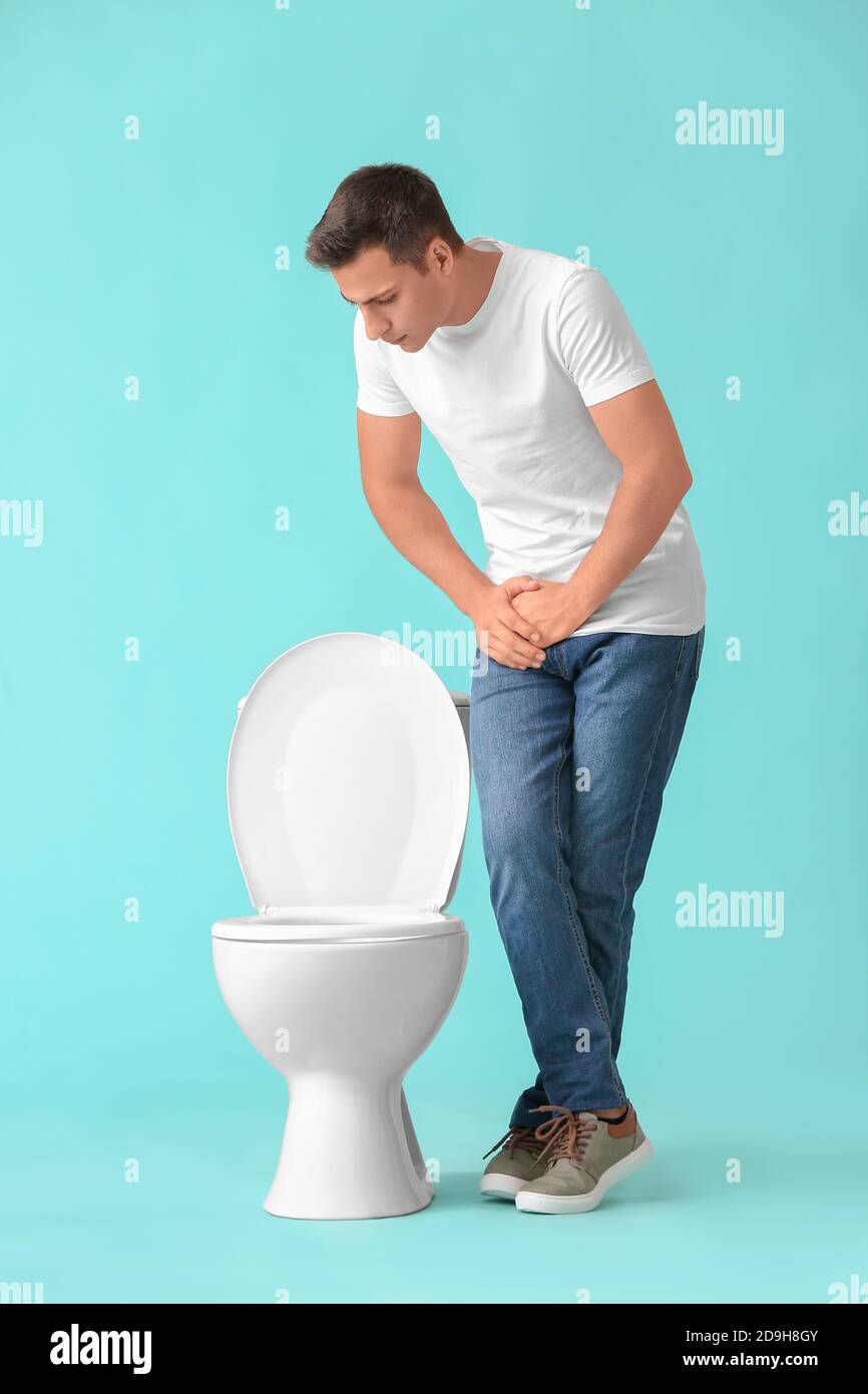 Man with problem of frequent urination on color background. Diabetes ...