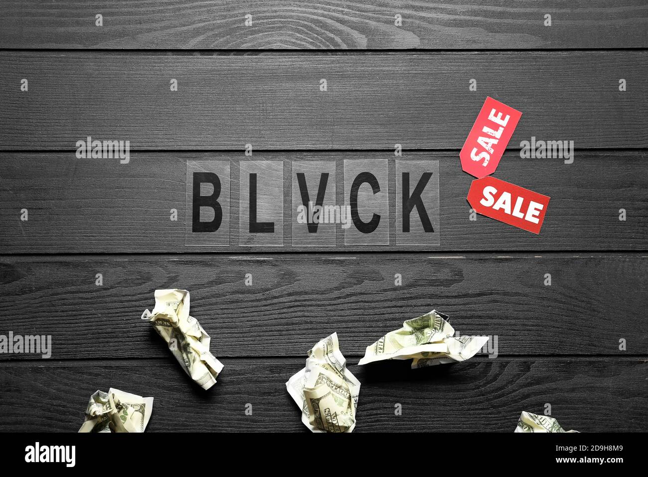 Text BLACK, money and tags with word SALE on dark wooden background ...