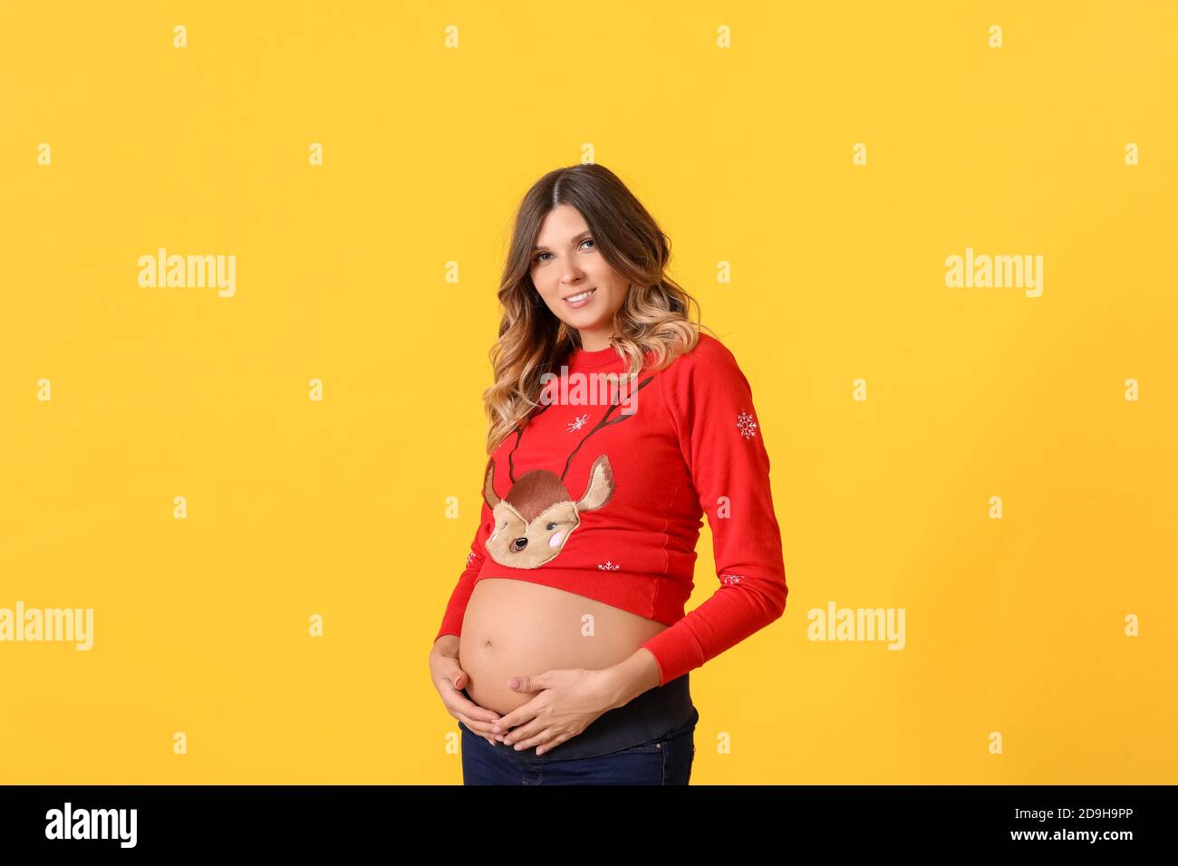 Beautiful pregnant woman on color background. Christmas celebration ...