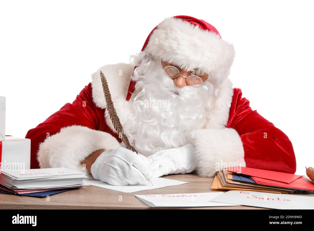 Santa Claus making list of gifts on white background Stock Photo - Alamy