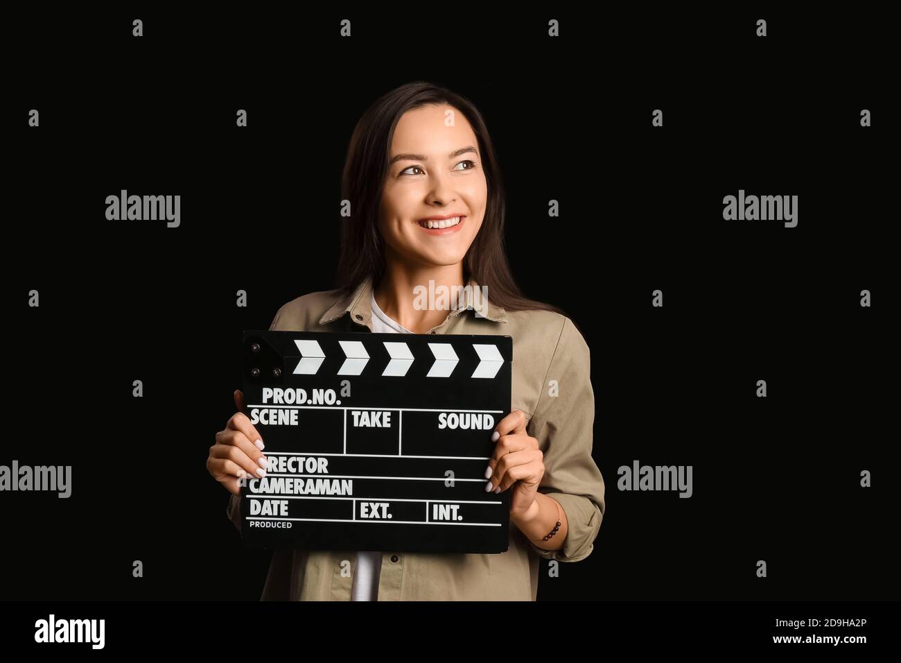 Young female film director with movie clapper on dark background Stock ...