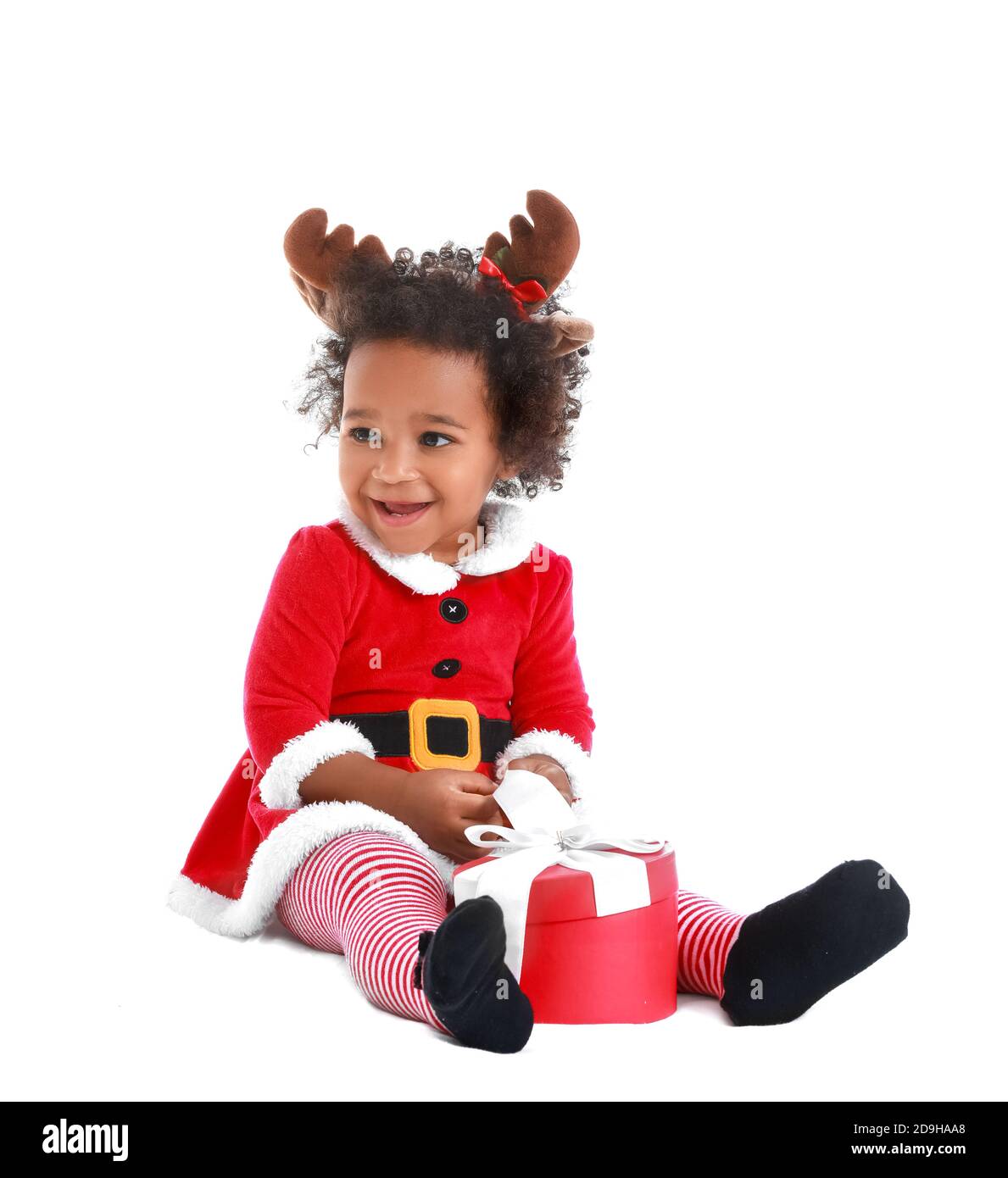 Cute African-American baby girl dressed as Santa and with Christmas ...