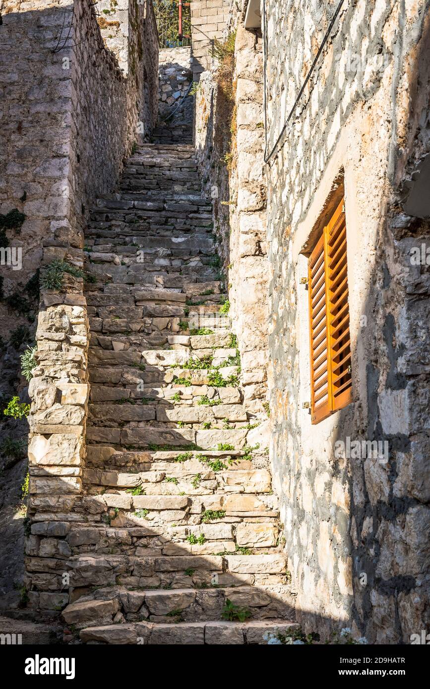 Street with stone stairs leading to the hill in Skradin town, Croatia ...