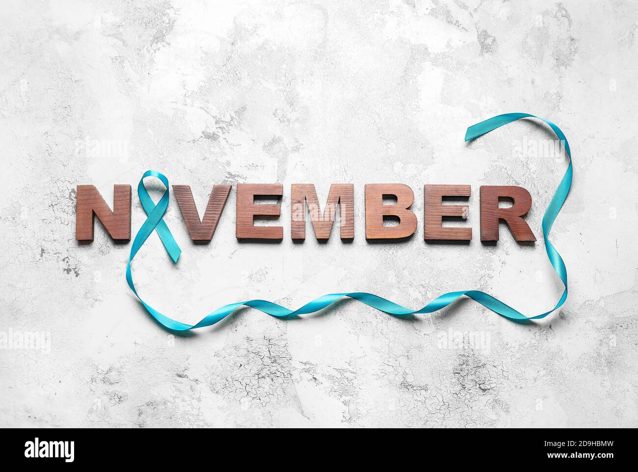Blue ribbon and word NOVEMBER on light background. Prostate cancer ...