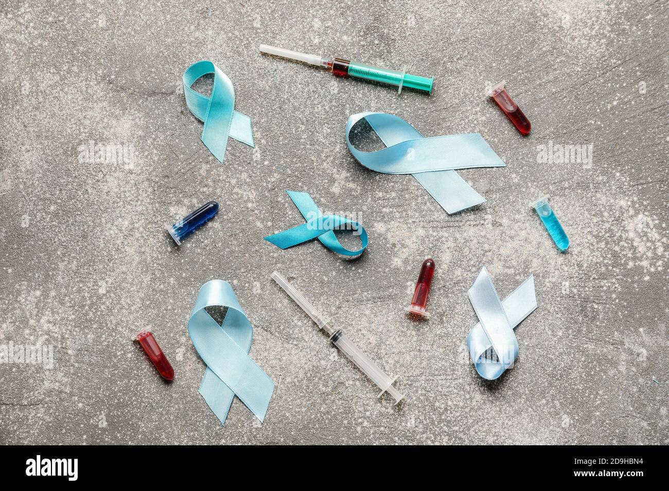 Blue ribbons, medication and blood sample on grey background. Prostate ...