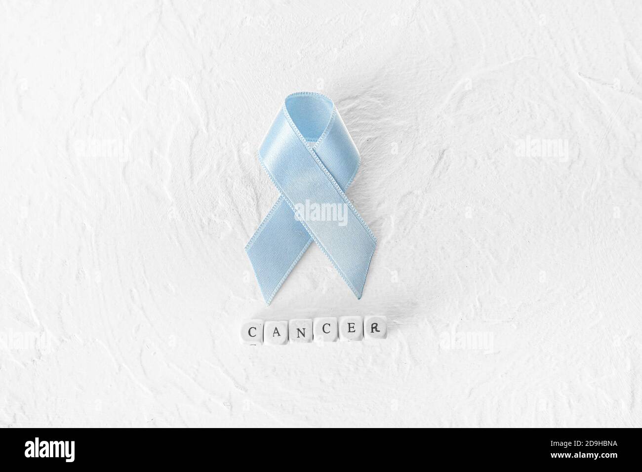 Blue ribbon and word CANCER on white background Stock Photo - Alamy