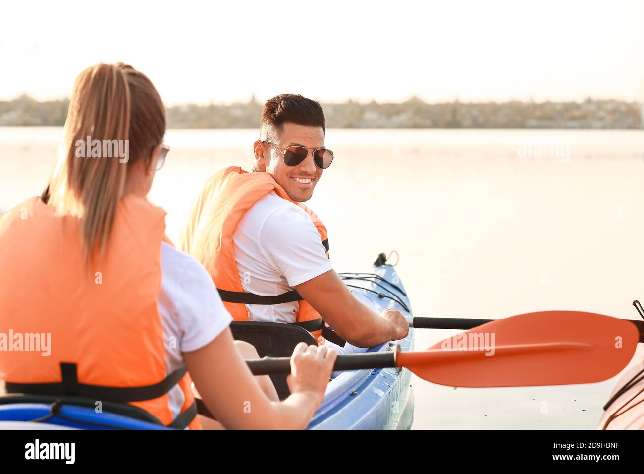 Young couple kayaking in river Stock Photo - Alamy