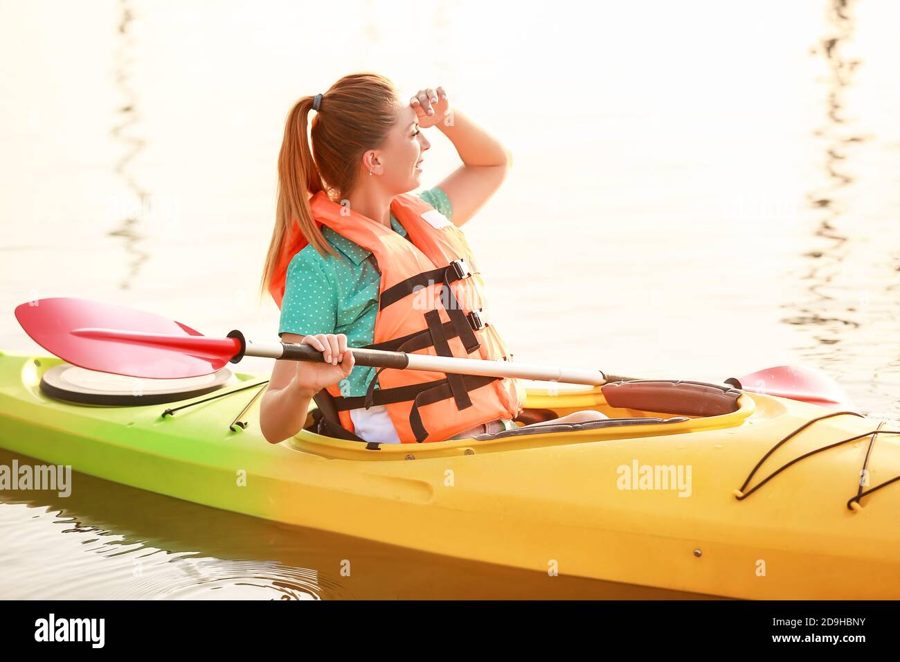 Young woman kayaking in river Stock Photo - Alamy