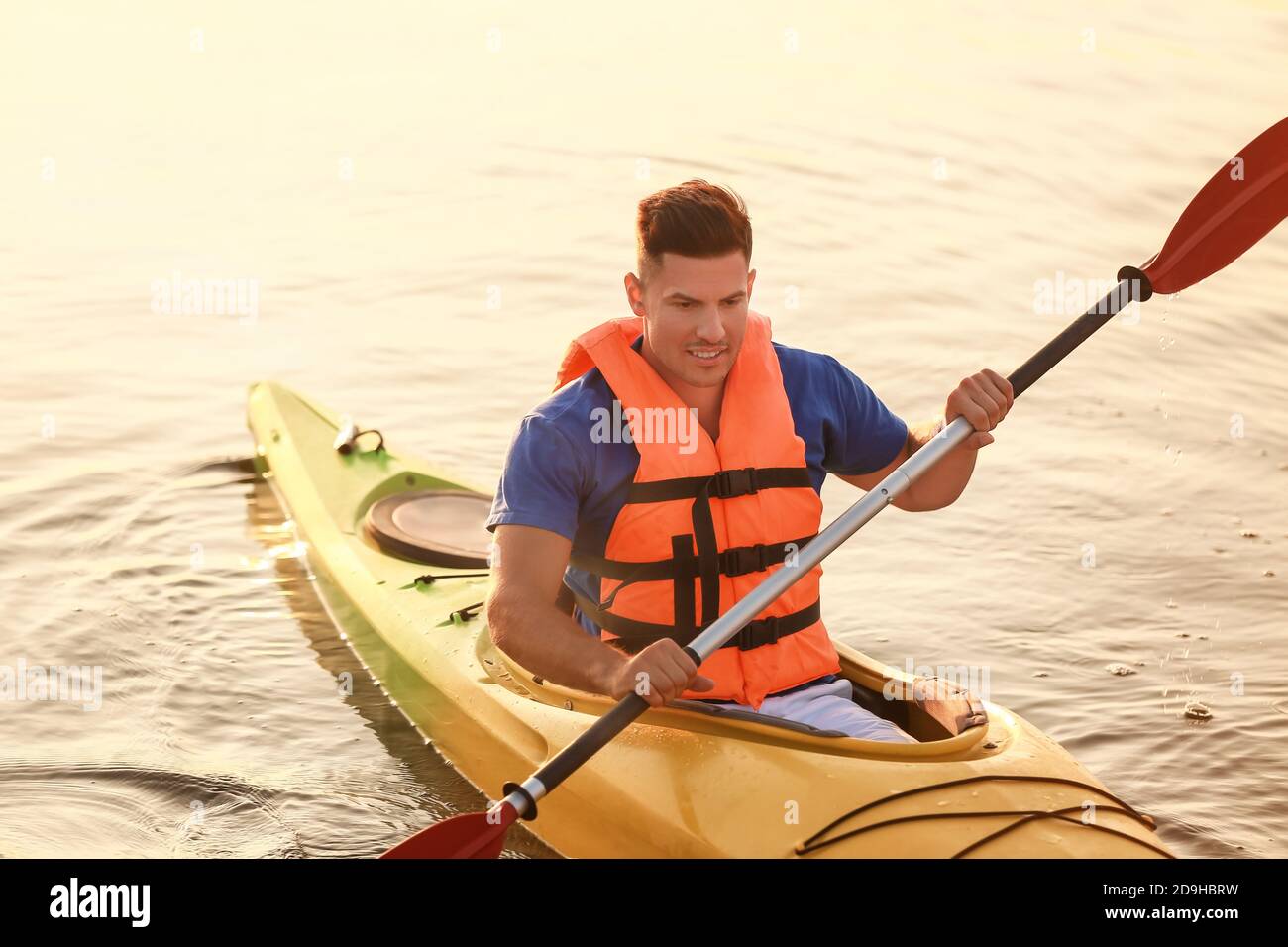 Young man kayaking in river Stock Photo - Alamy