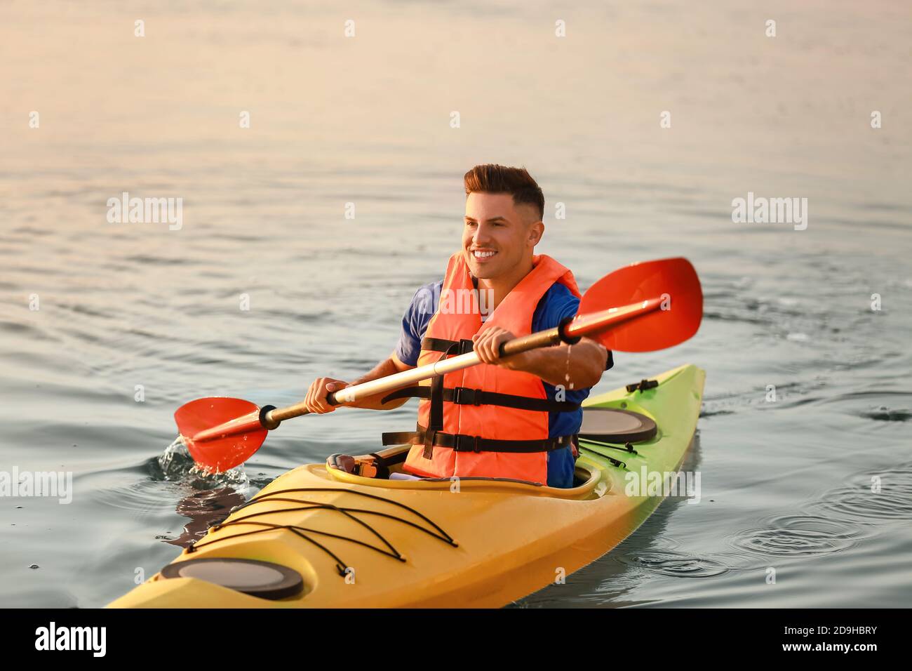 Young man kayaking in river Stock Photo - Alamy
