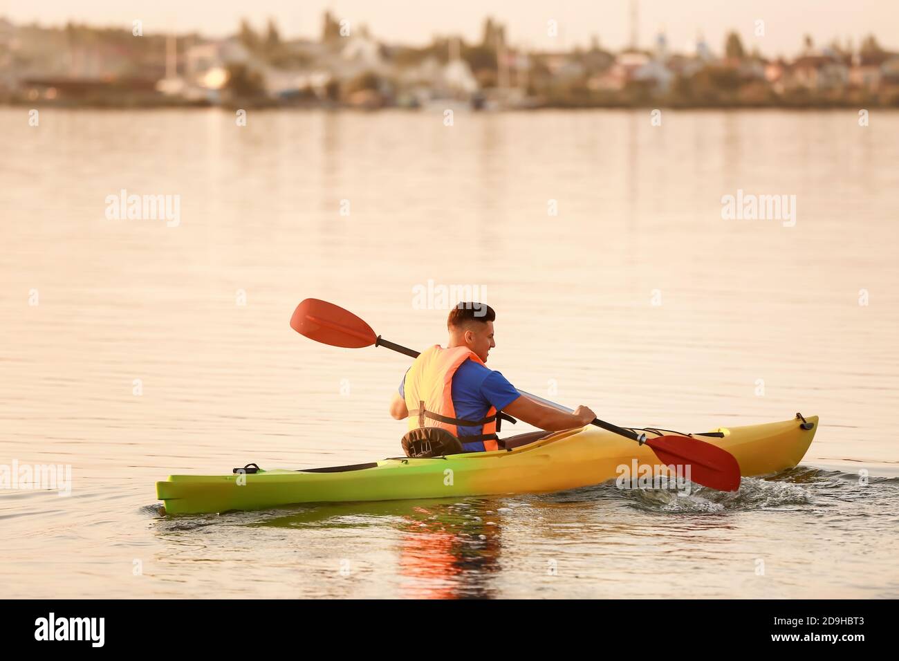 Young man kayaking in river Stock Photo - Alamy