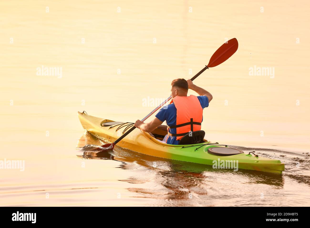 Young man kayaking in river Stock Photo - Alamy