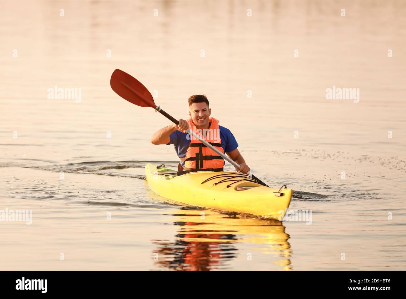 Young man kayaking in river Stock Photo - Alamy