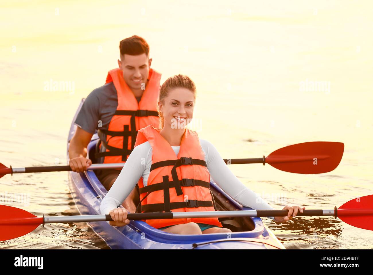 Young couple kayaking in river Stock Photo - Alamy