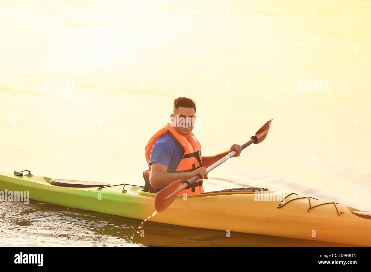 Young man kayaking in river Stock Photo - Alamy