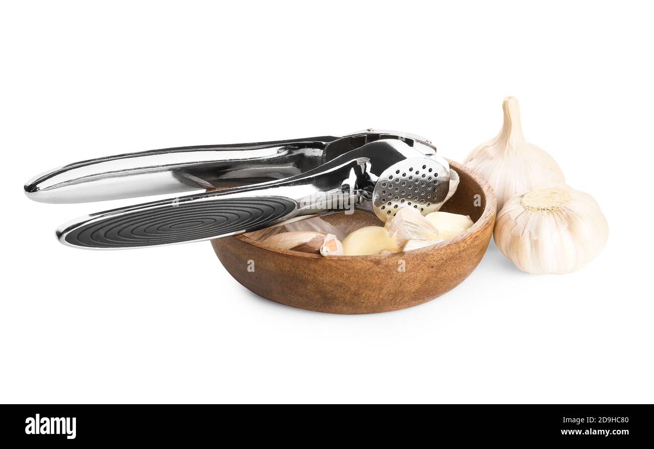 Garlic press with plate on white background Stock Photo - Alamy