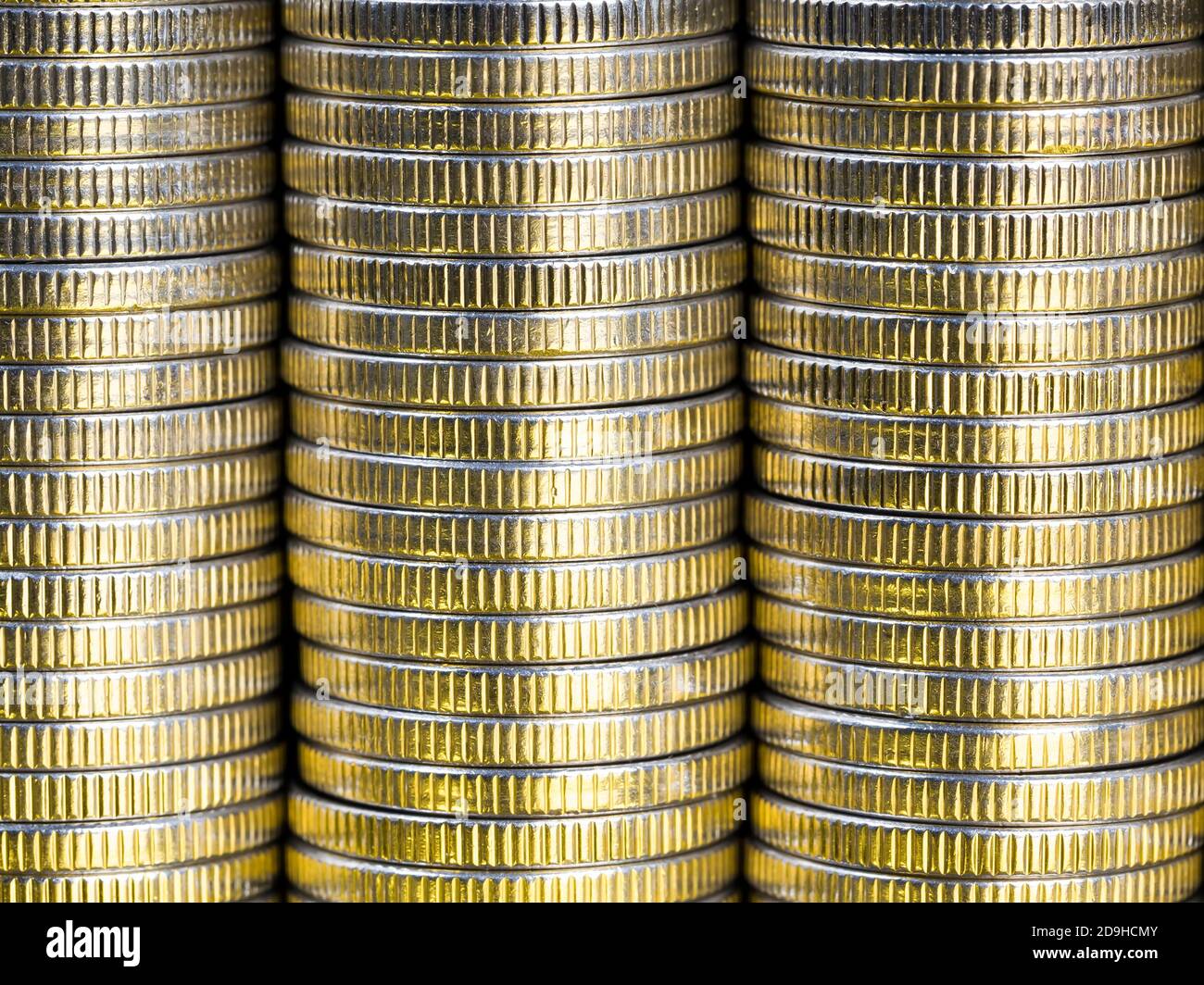 many round metal coins of silver color illuminated in yellow Stock ...