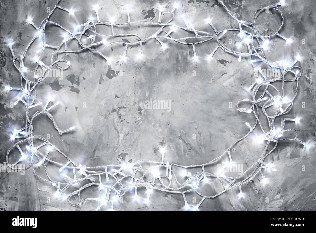 Frame made of Christmas lights on grey background Stock Photo - Alamy